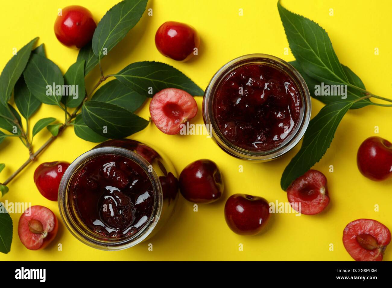 Cherry jam and ingredients on yellow background Stock Photo - Alamy