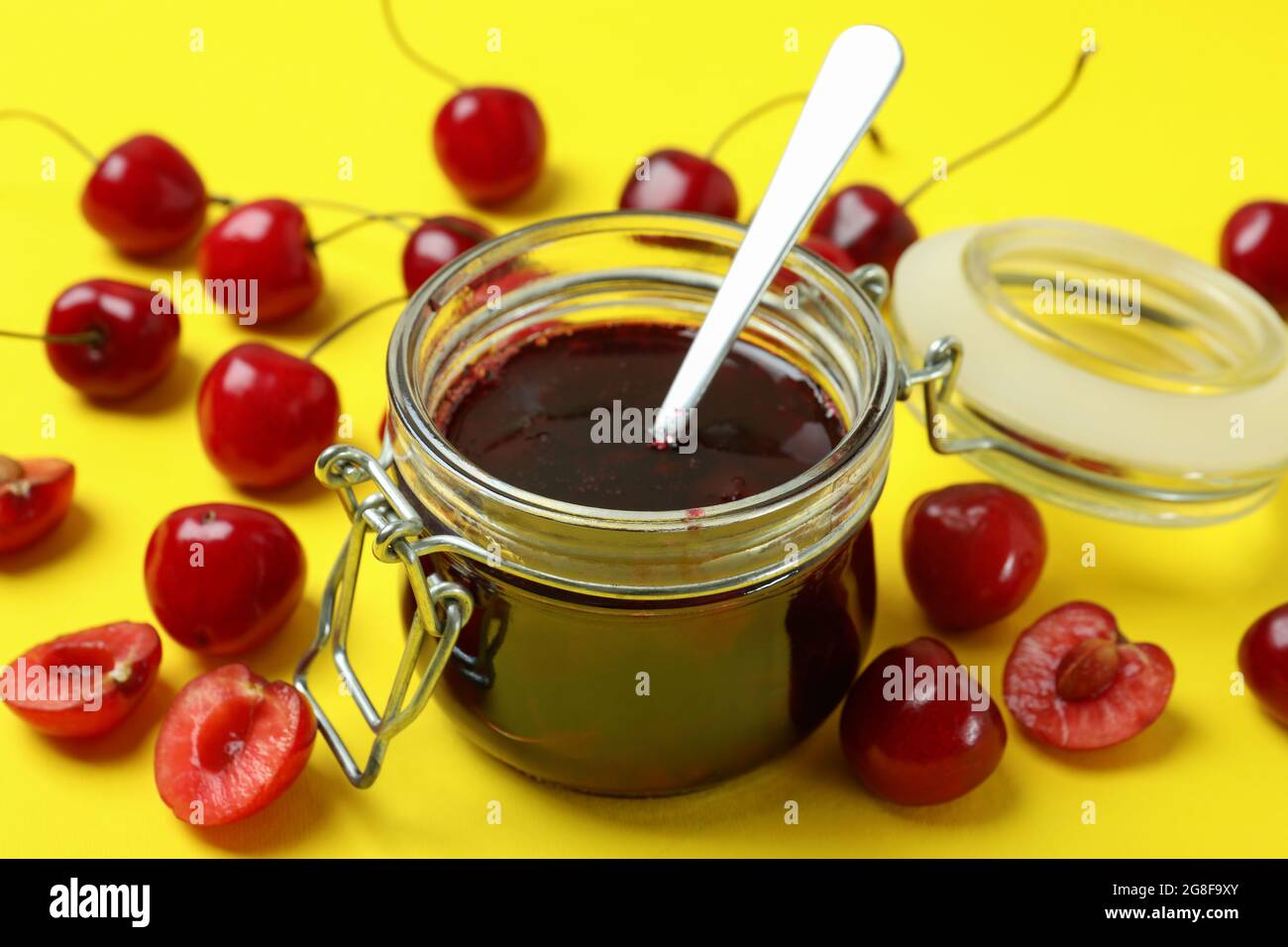 Cherry jam and ingredients on yellow background Stock Photo - Alamy