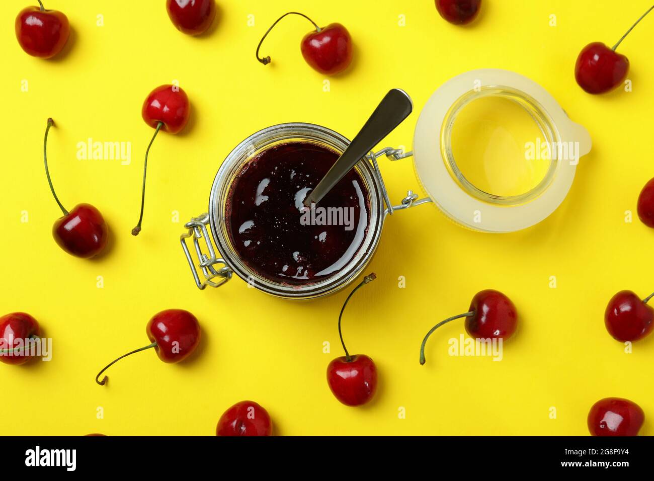 Cherry jam and ingredients on yellow background Stock Photo - Alamy
