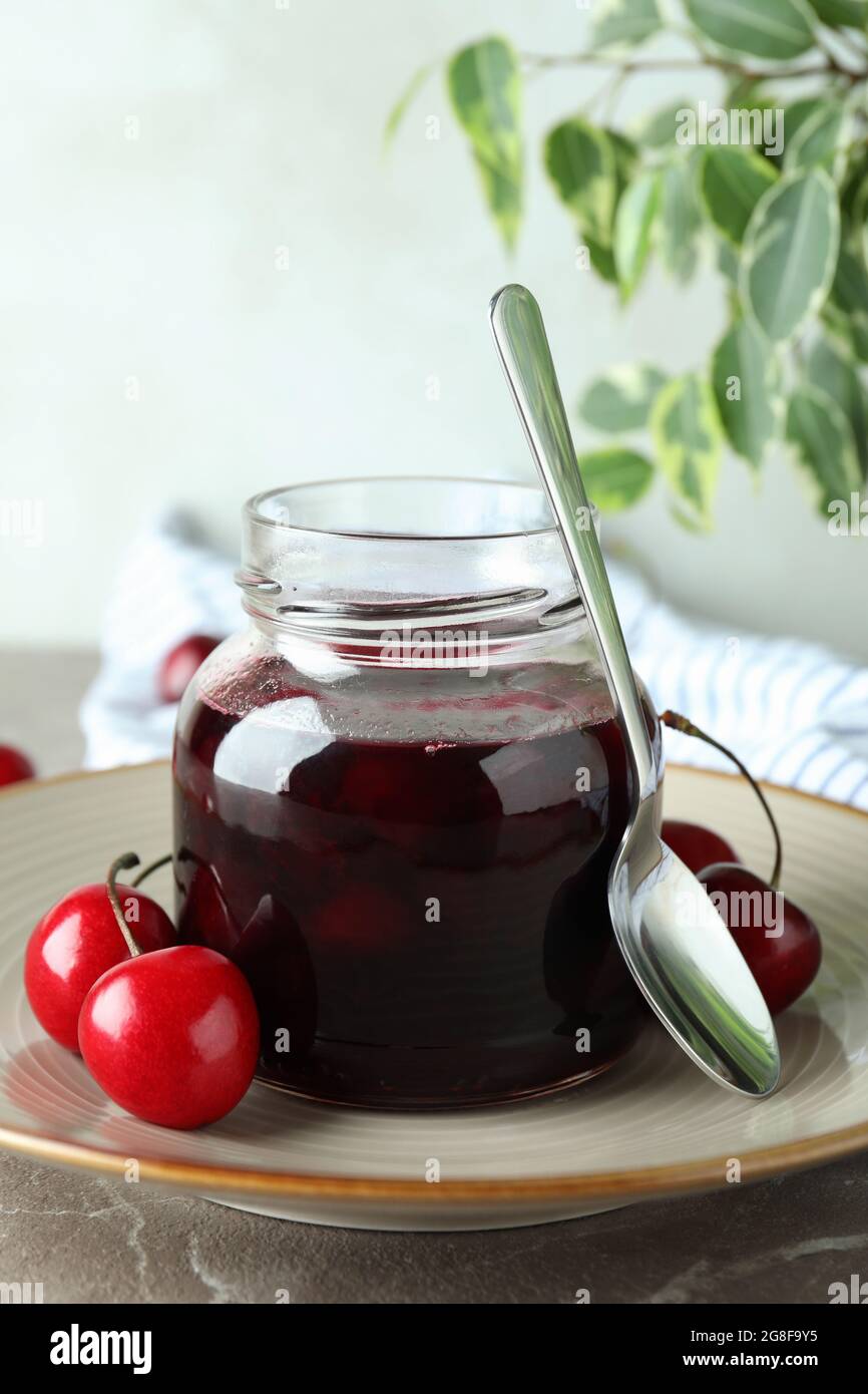 Cherry jam and ingredients on gray textured table Stock Photo - Alamy