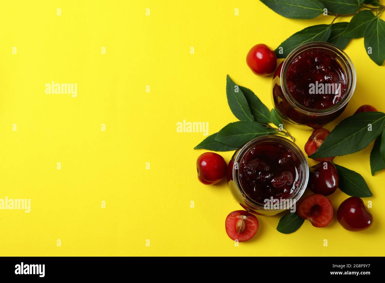 Cherry jam and ingredients on yellow background Stock Photo - Alamy