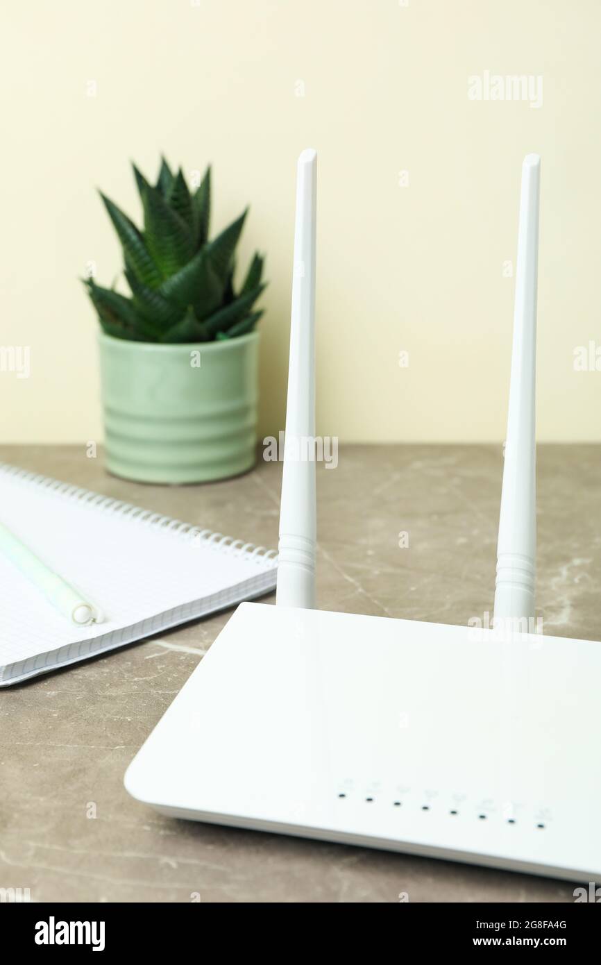 Workplace with Wi - fi router on gray textured table Stock Photo - Alamy
