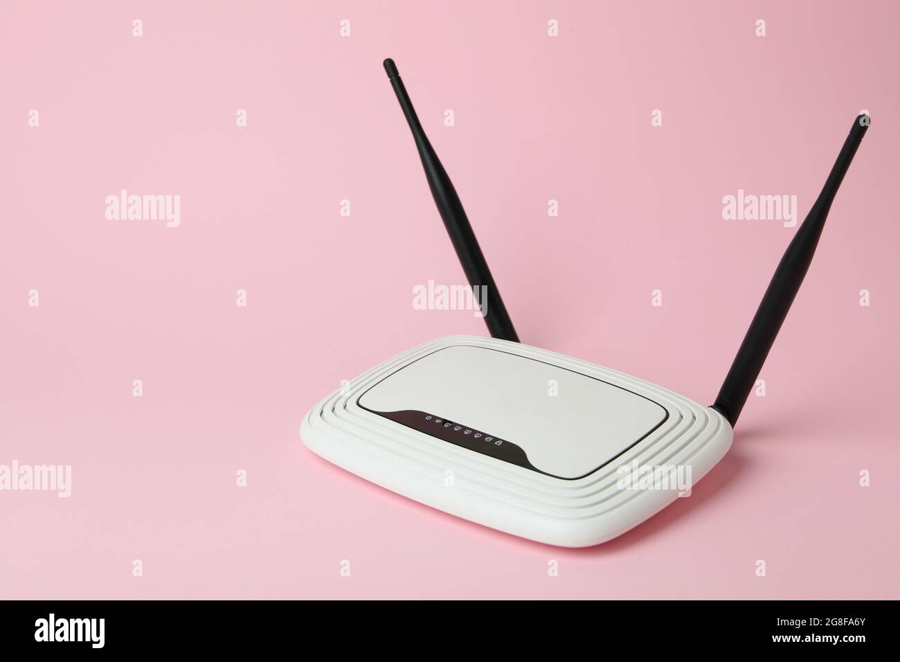 Wi-Fi router with external antennas on pink background Stock Photo - Alamy