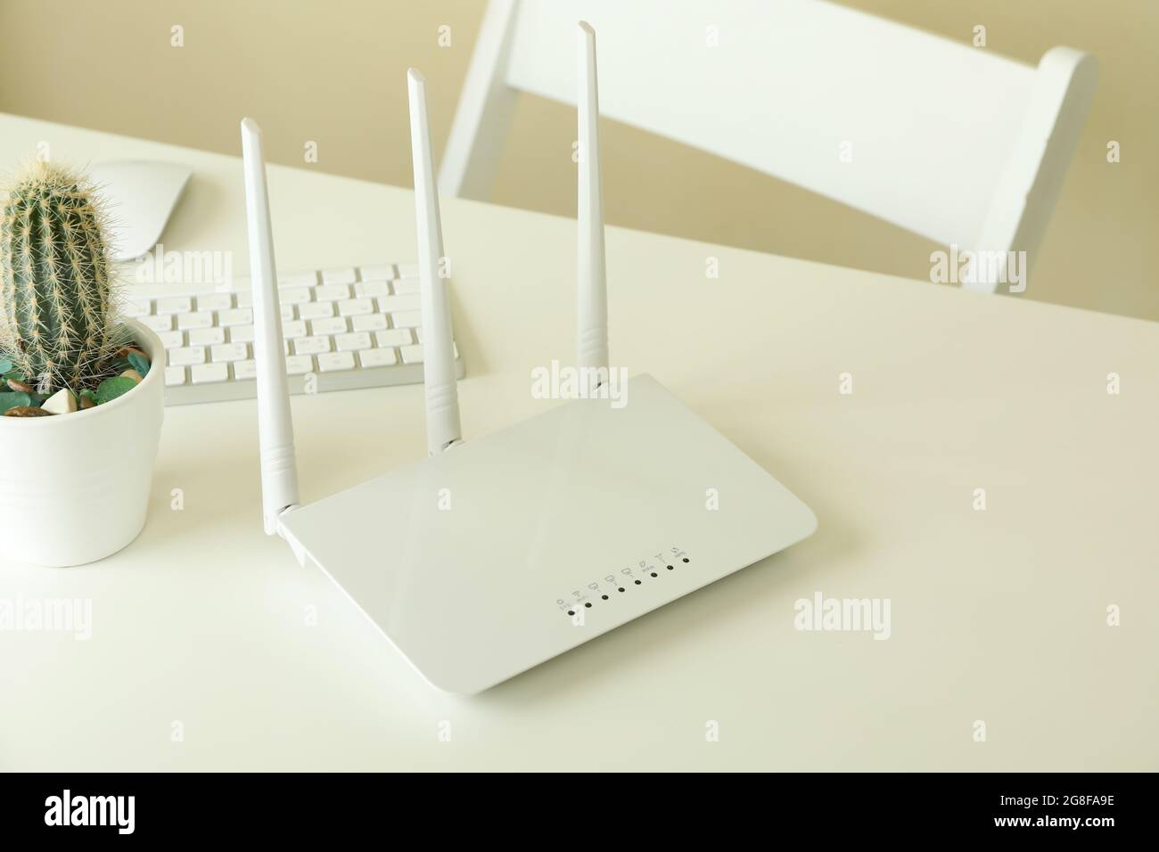 Workplace with Wi - fi router on white table Stock Photo - Alamy