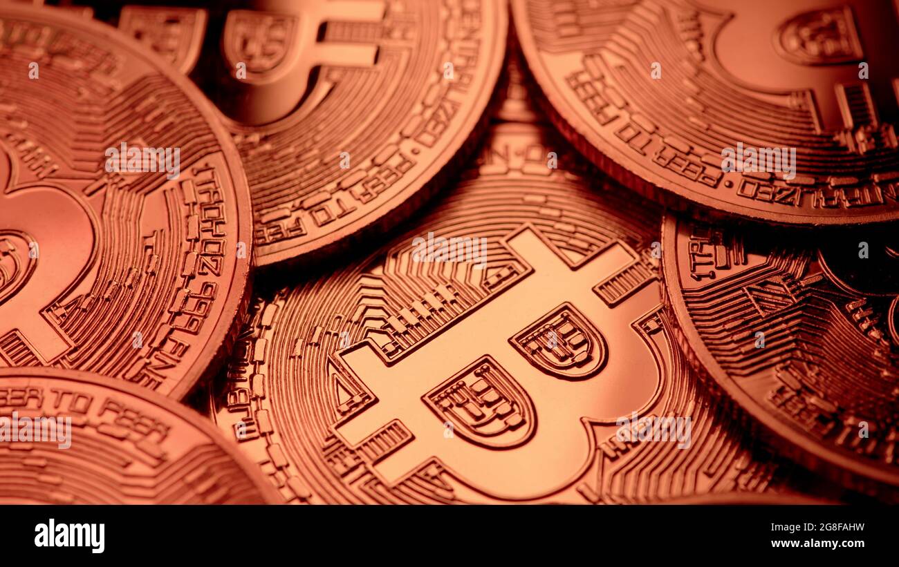 Close-up of bitcoins rotating under copper light. Online payment ...