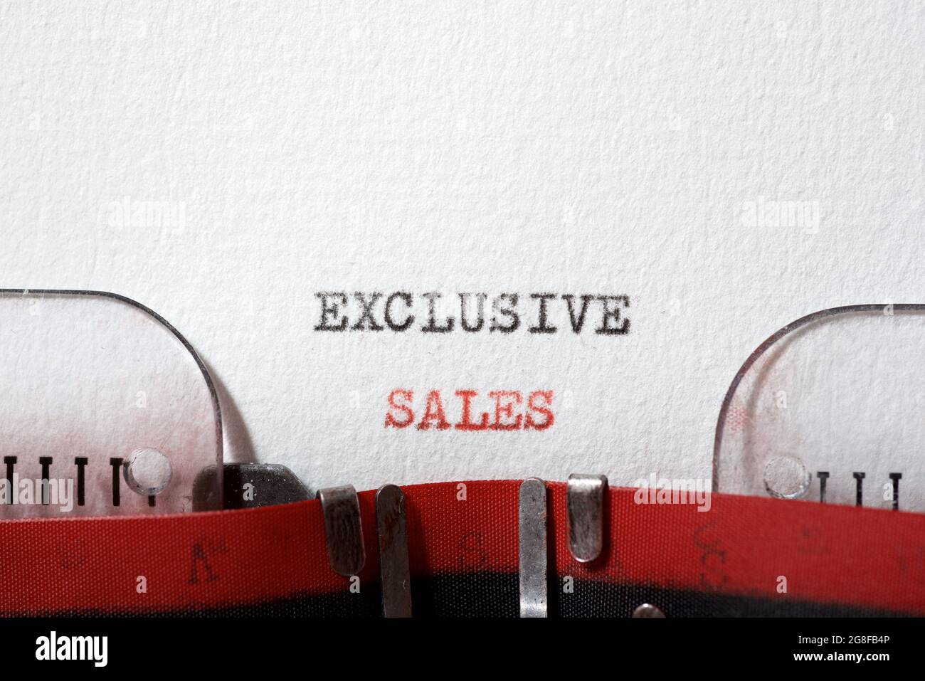 Exclusive sales phrase written with a typewriter Stock Photo - Alamy