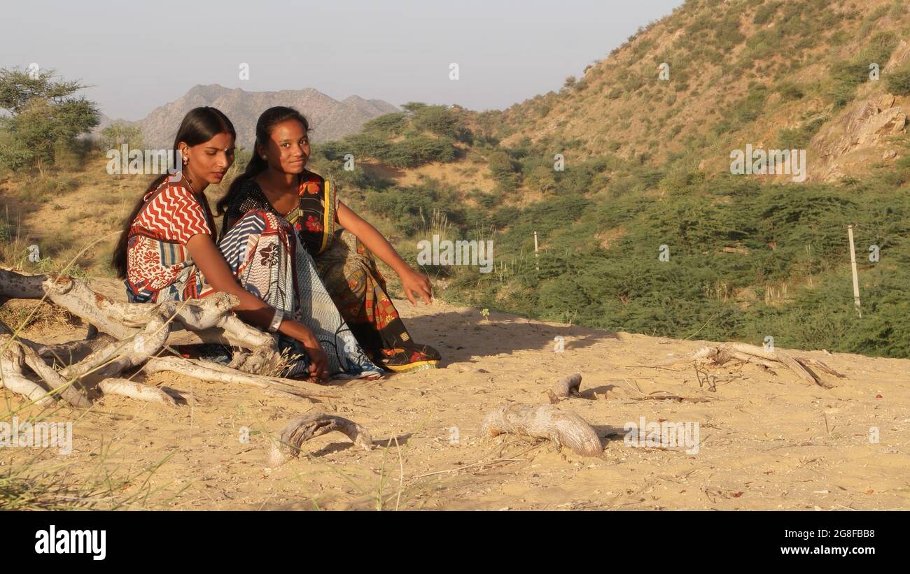 Happy Indian girls in traditional clothes sitting outdoor Stock Photo ...
