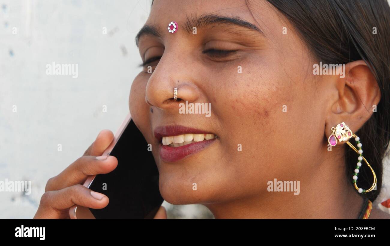 Happy Indian female in traditional clothes talking on the phone Stock ...
