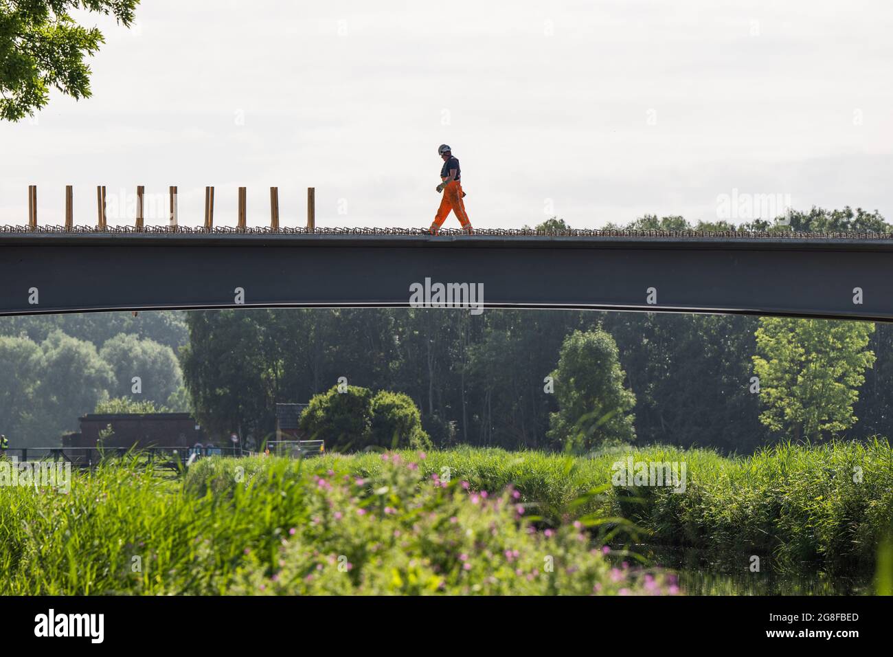 Sande, Germany. 20th July, 2021. A Deutsche Bahn worker walks over a ...