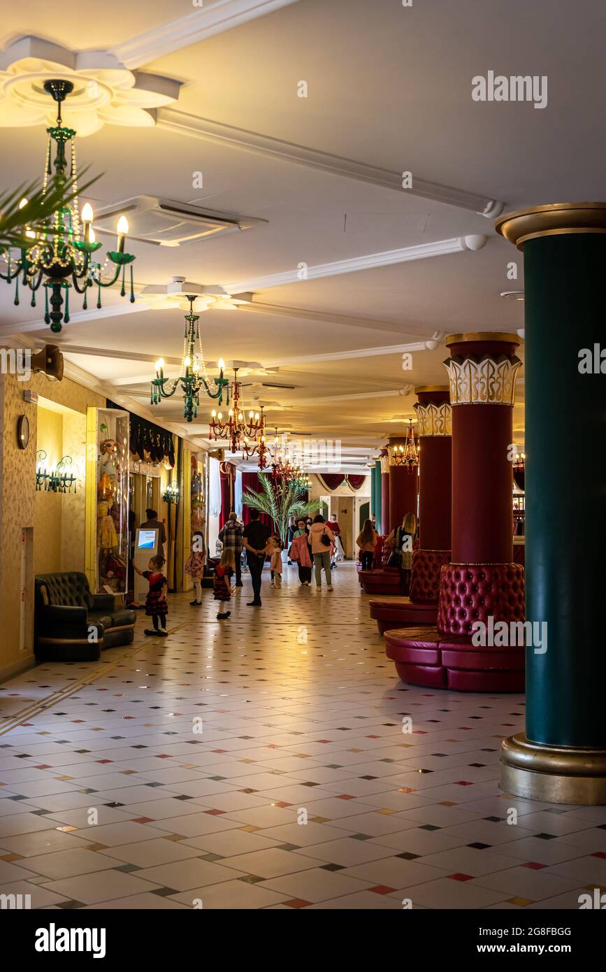 Little kids with parents walk along puppet theater hall Stock Photo - Alamy
