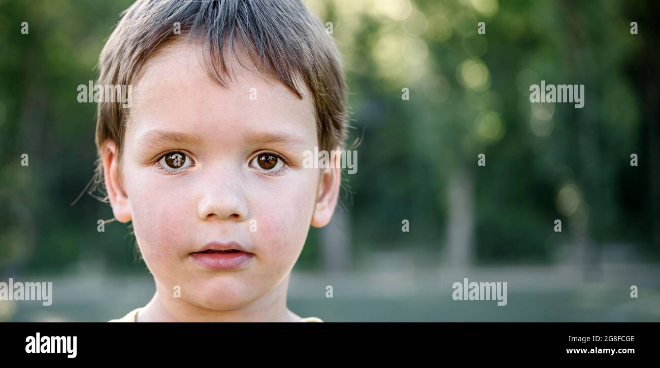 A cute little boy in yellow T-shirt in the football field Stock Photo ...