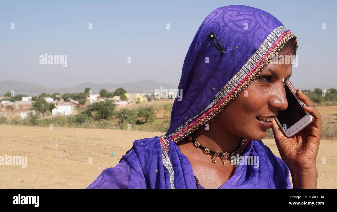 Happy Indian female in traditional clothes talking on the phone Stock ...