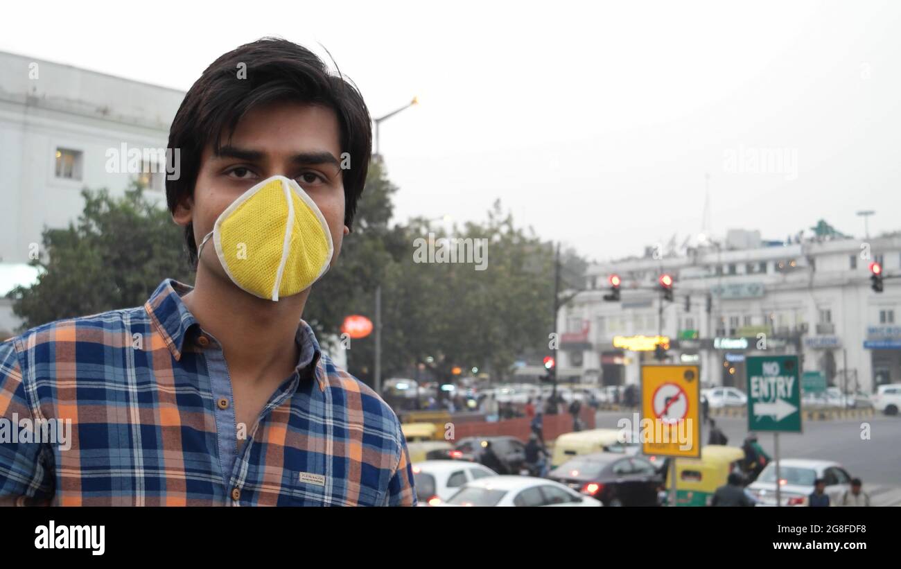 Indian guy with a mask posing in the street Stock Photo - Alamy