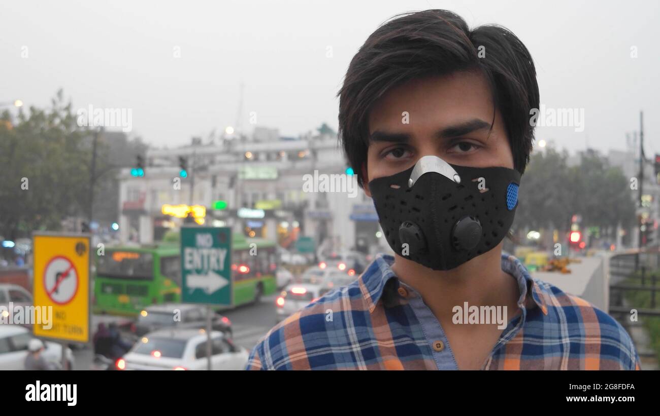 Indian guy with a mask posing in the street Stock Photo - Alamy