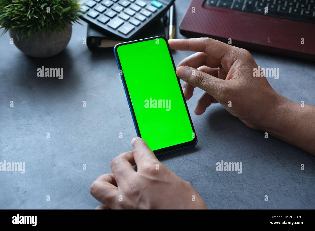 Man scrolling on phone green hi-res stock photography and images - Alamy