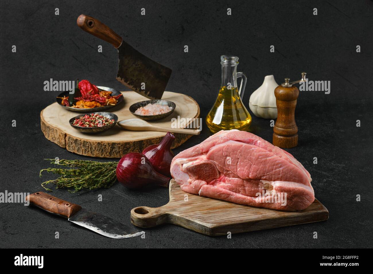 Raw slice of beef steamship round with cooking ingredients on black ...