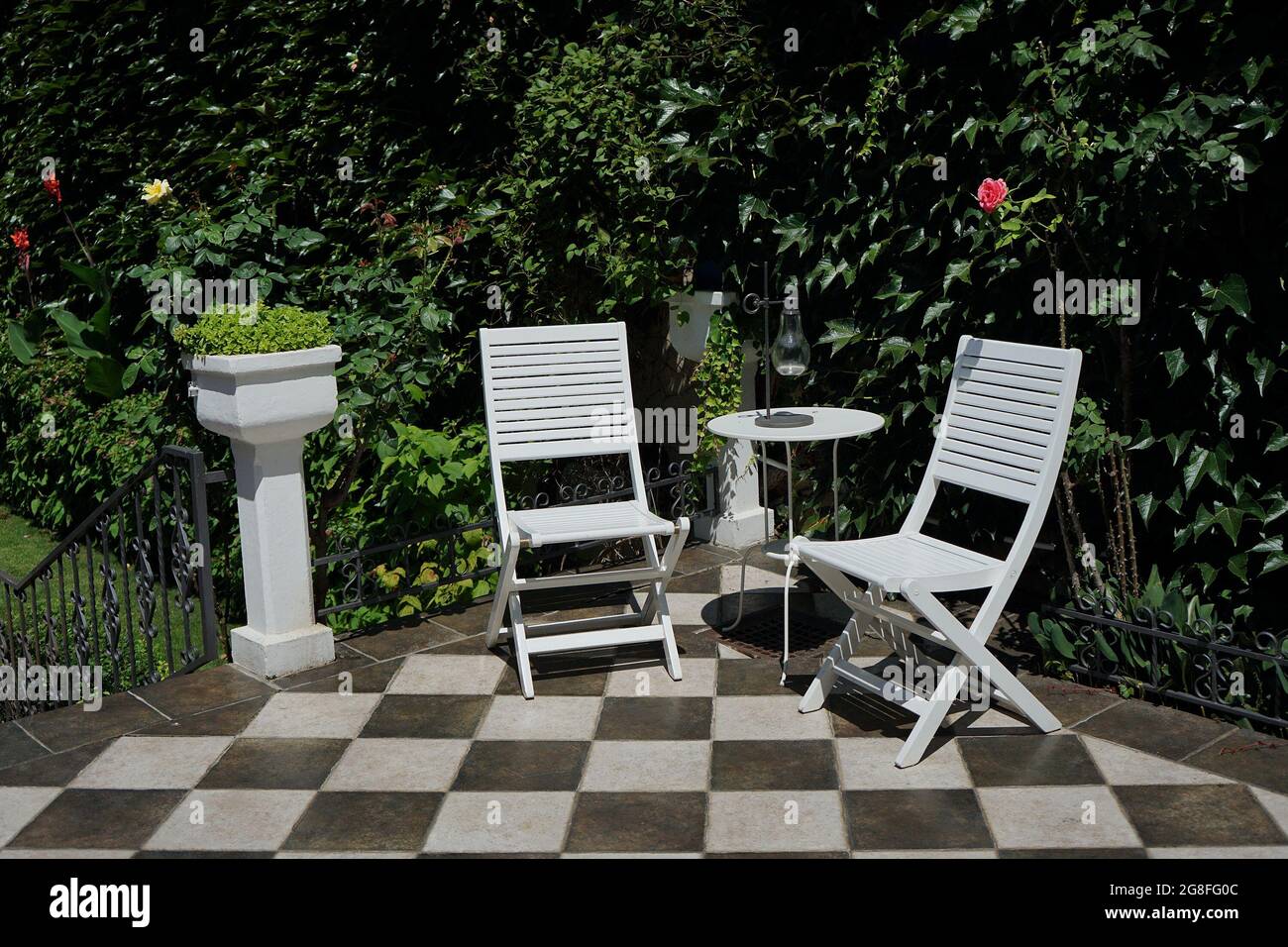 Two white chairs and table on the terace in the house yard Stock Photo ...