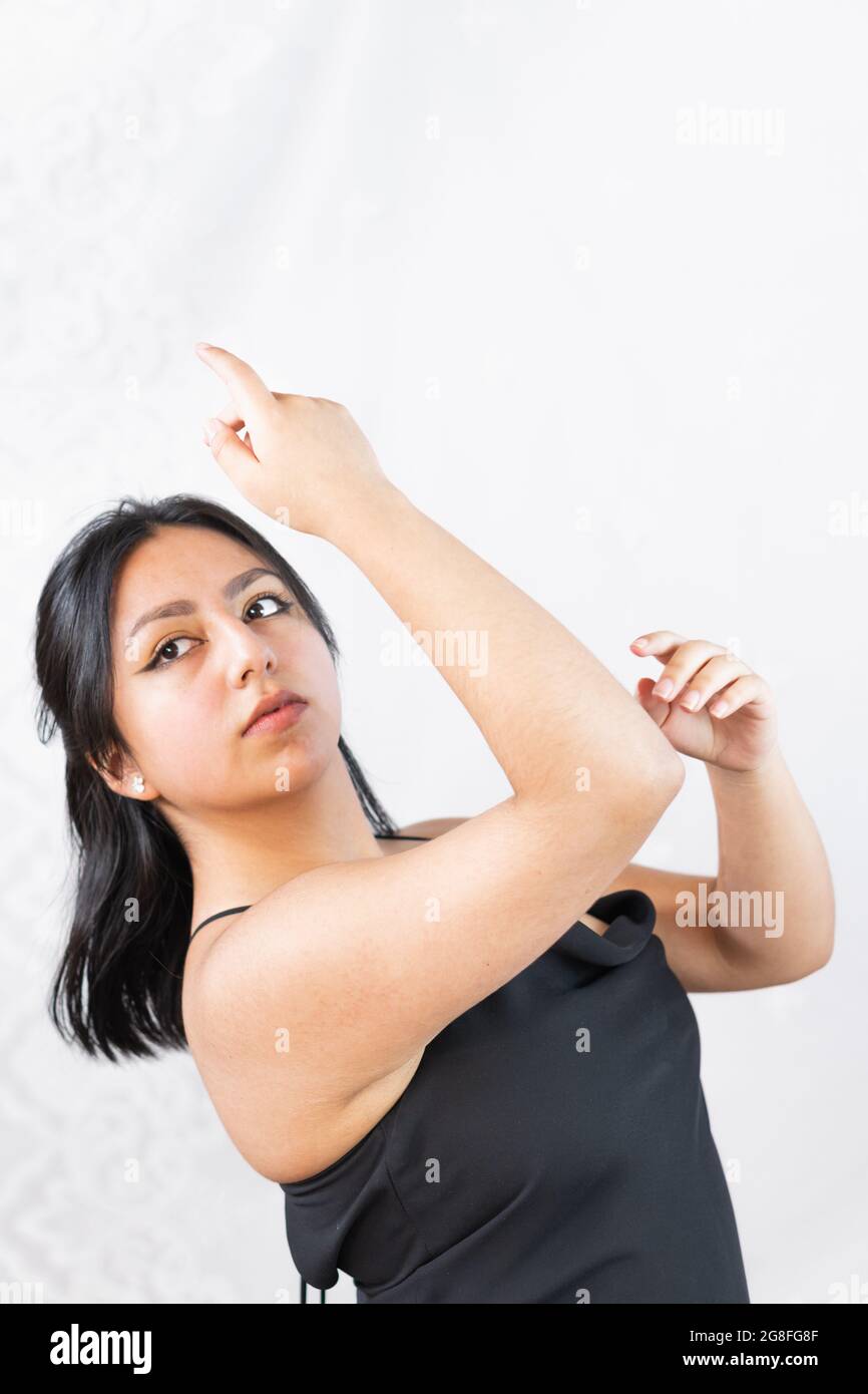 Young female practicing dance steps to develop her talent on a white ...