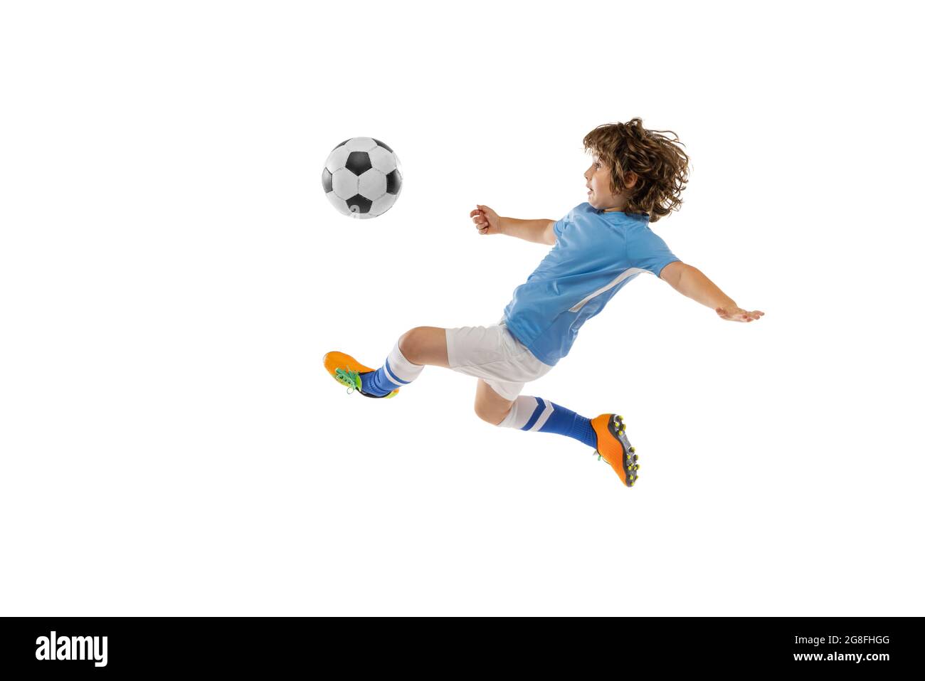 Little boy, football soccer player in action, motion training isolated ...