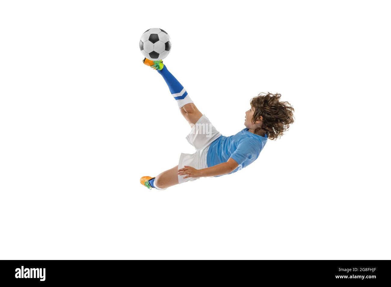 Little boy, football soccer player in action, motion training isolated ...