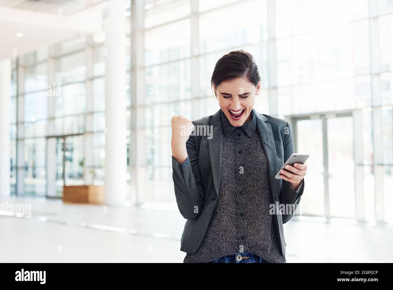 Excited businesswoman cheering hi-res stock photography and images - Alamy