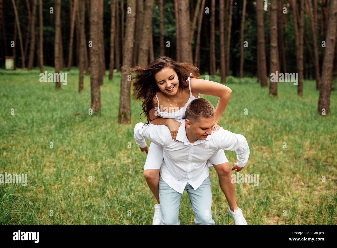 Smiling couple having fun in the park. Love and tenderness, dating ...