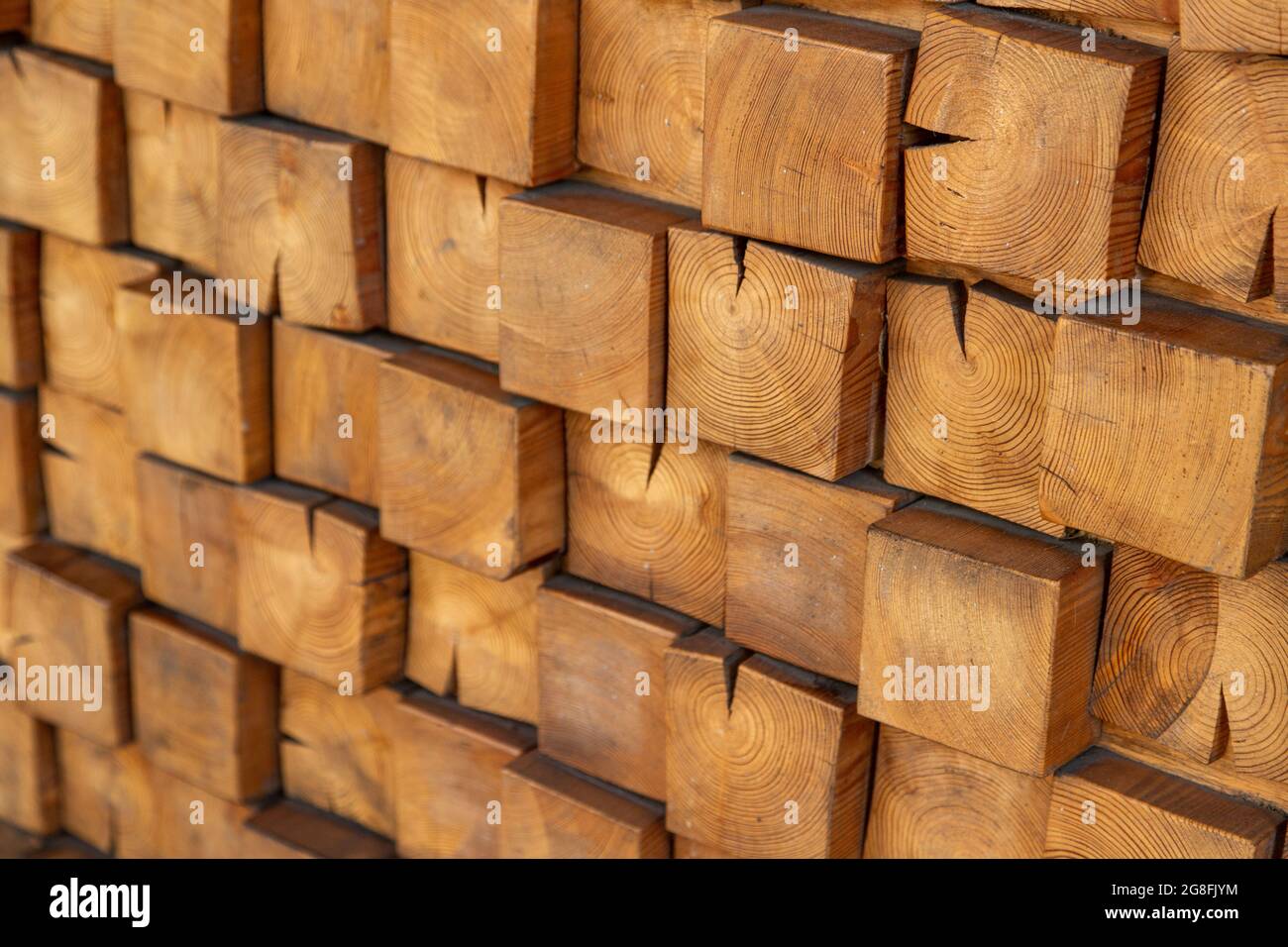 Wooden, textured wall lined with wooden cubes, longitudinal cuts of a ...