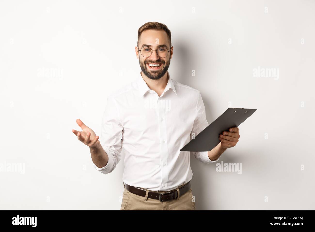 Handsome boss looking satisfied, holding clipboard and praising you ...
