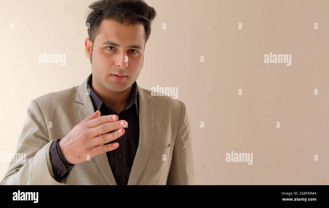 Portrait of a handsome Indian businessman in a suit Stock Photo - Alamy