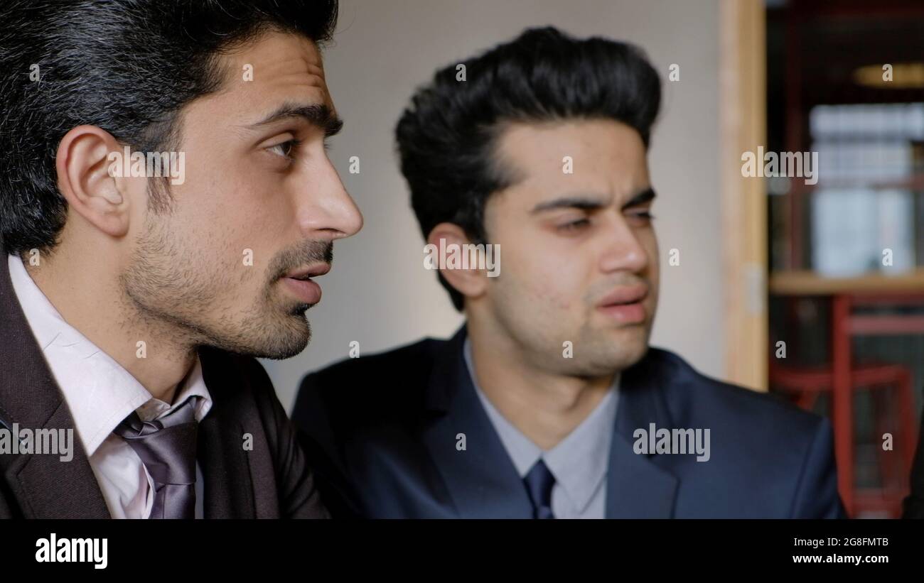 Indian colleagues sitting around a table and discussing their work ...