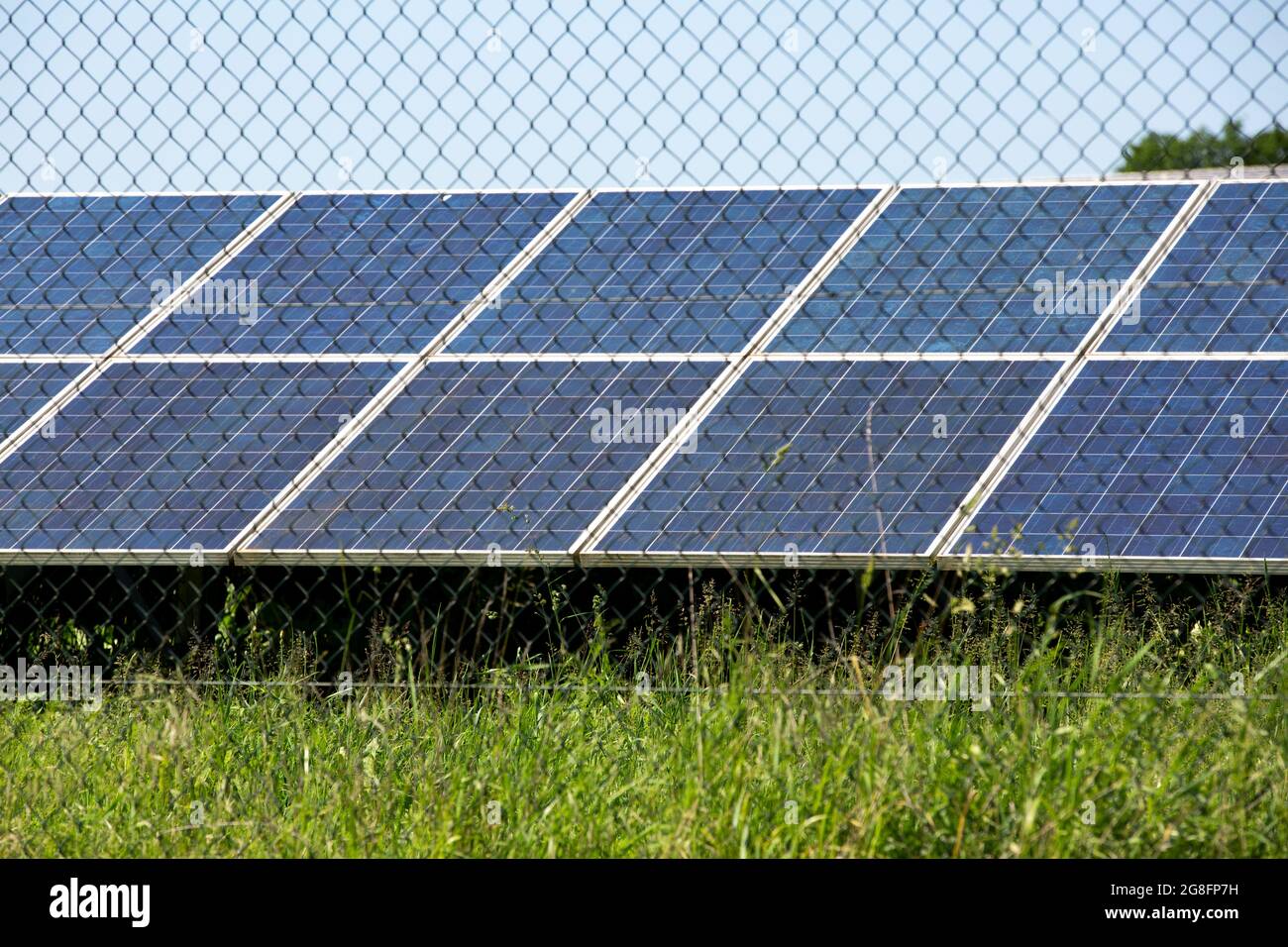 Photovoltaic Array In The Open Behind A Chain-link Fence. Iconic Image ...