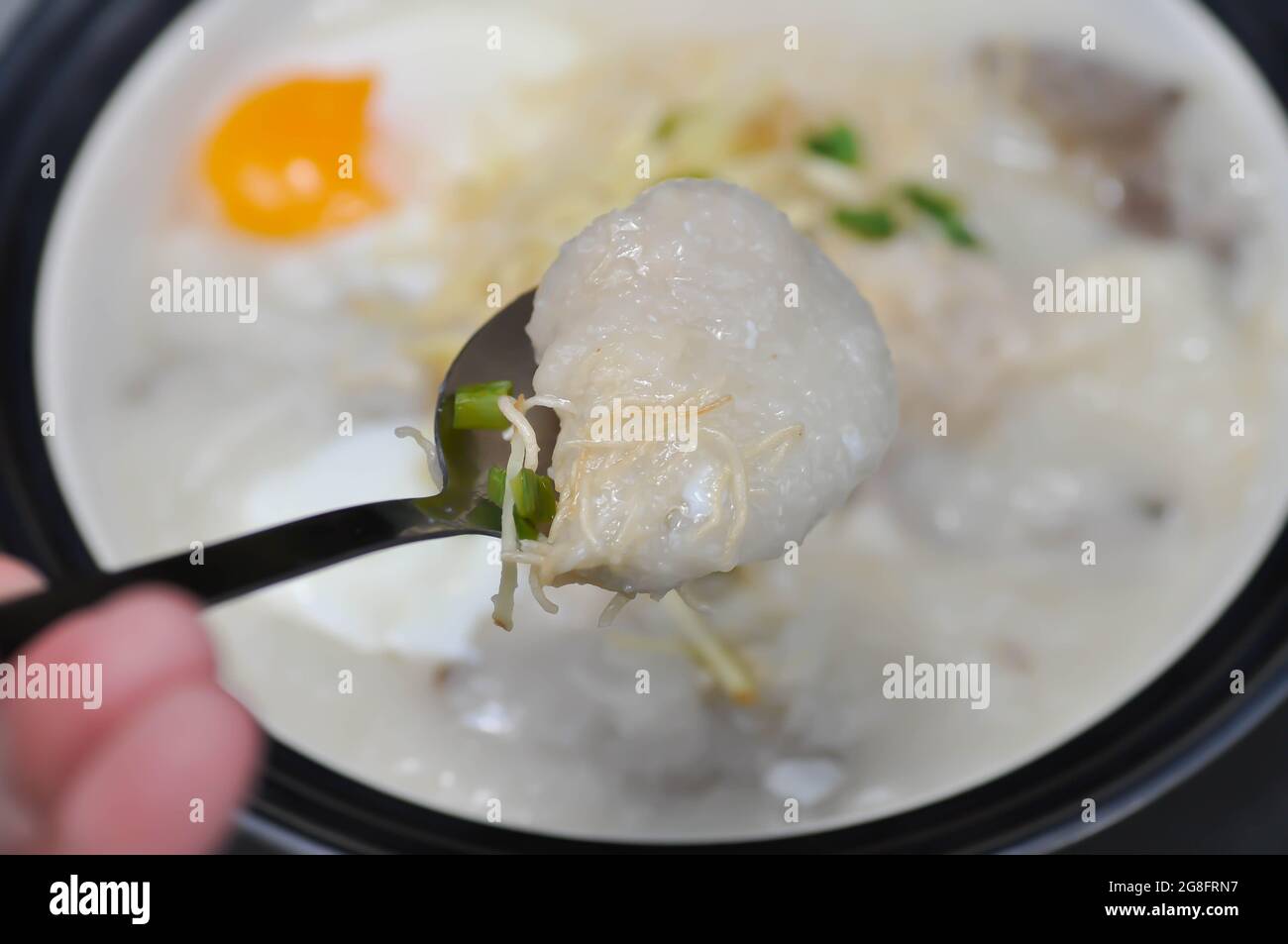 rice gruel, rice porridge or congee with pork and egg or eating rice ...