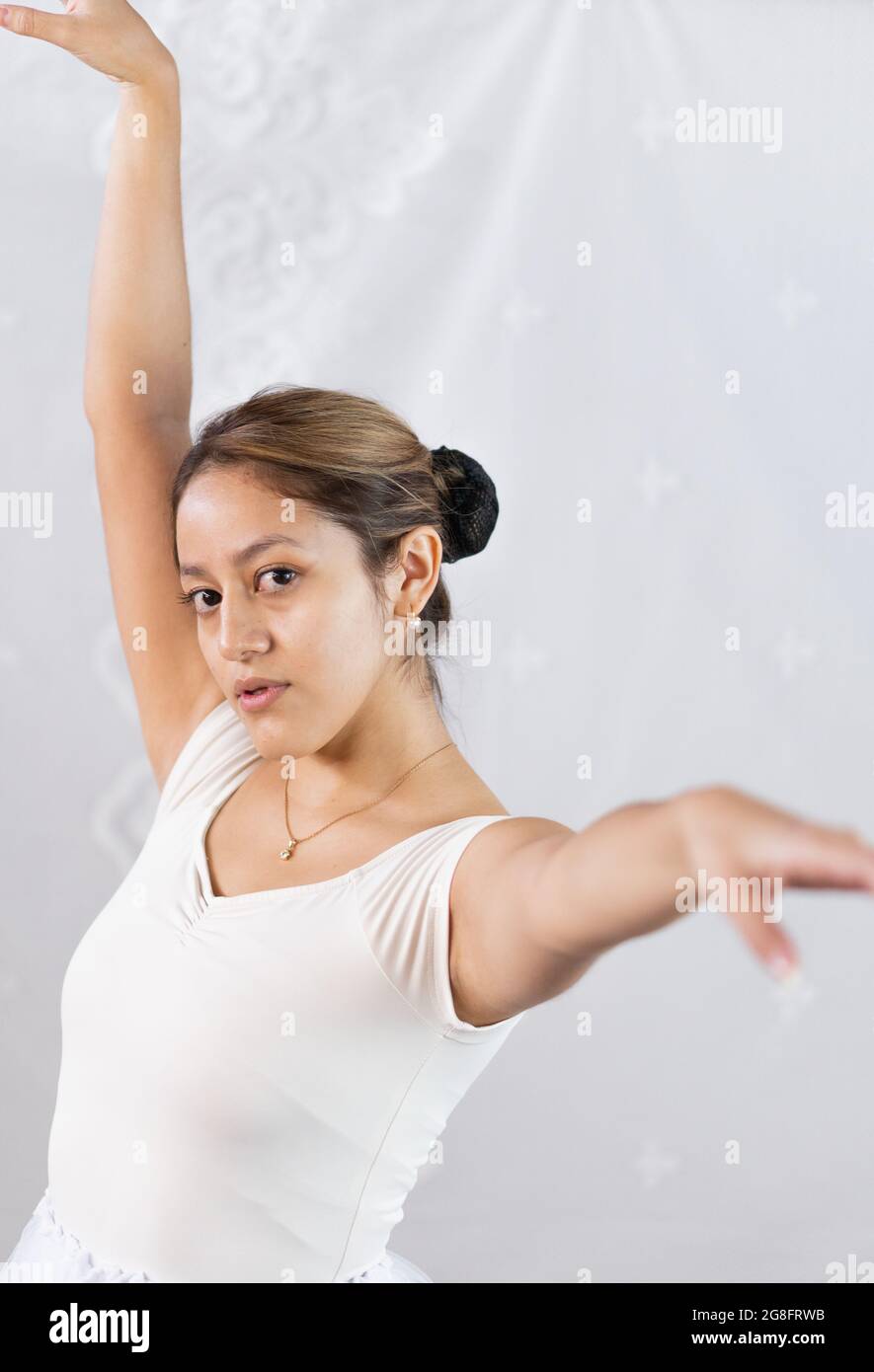 Young female in ballet clothing posing for the camera, taking different ...
