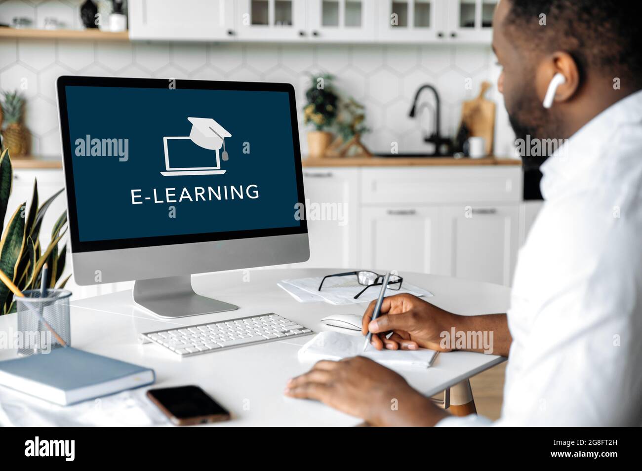 E-learning concept. African American smart confident guy sitting at ...