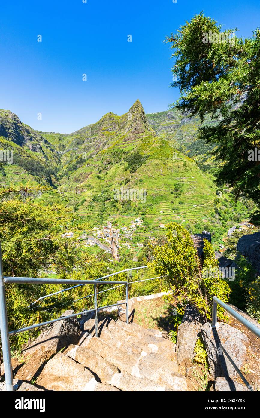 Steep steps on mountain path to the green alpine valley and village of ...