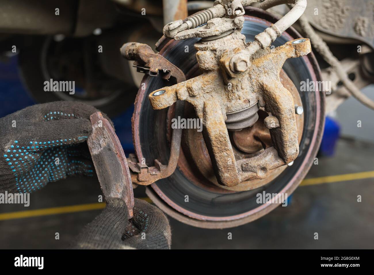 An auto mechanic removed a completely worn out brake pad, a concept on ...