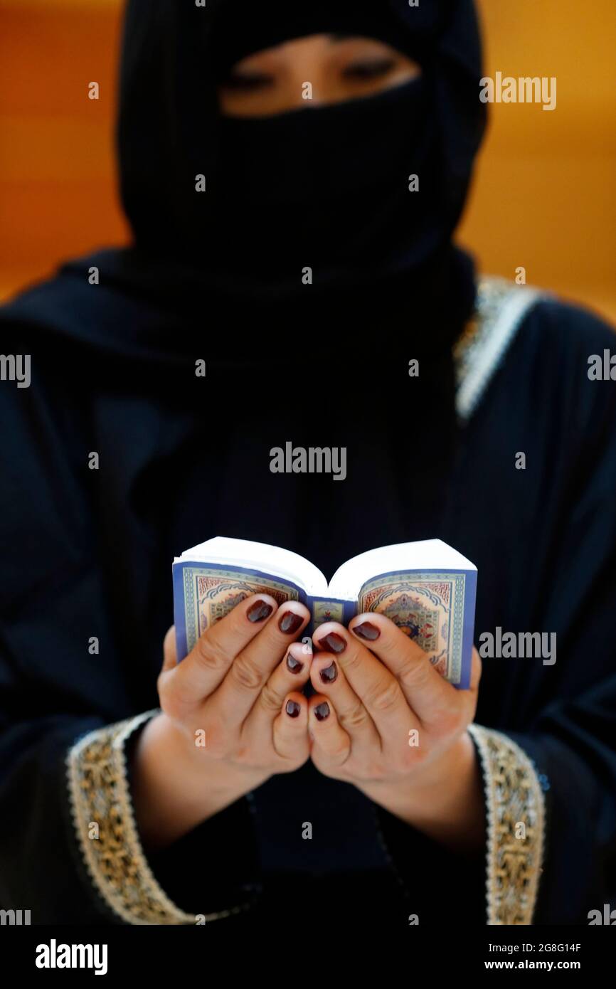 Muslim woman reading the Noble Quran, United Arab Emirates, Middle East ...