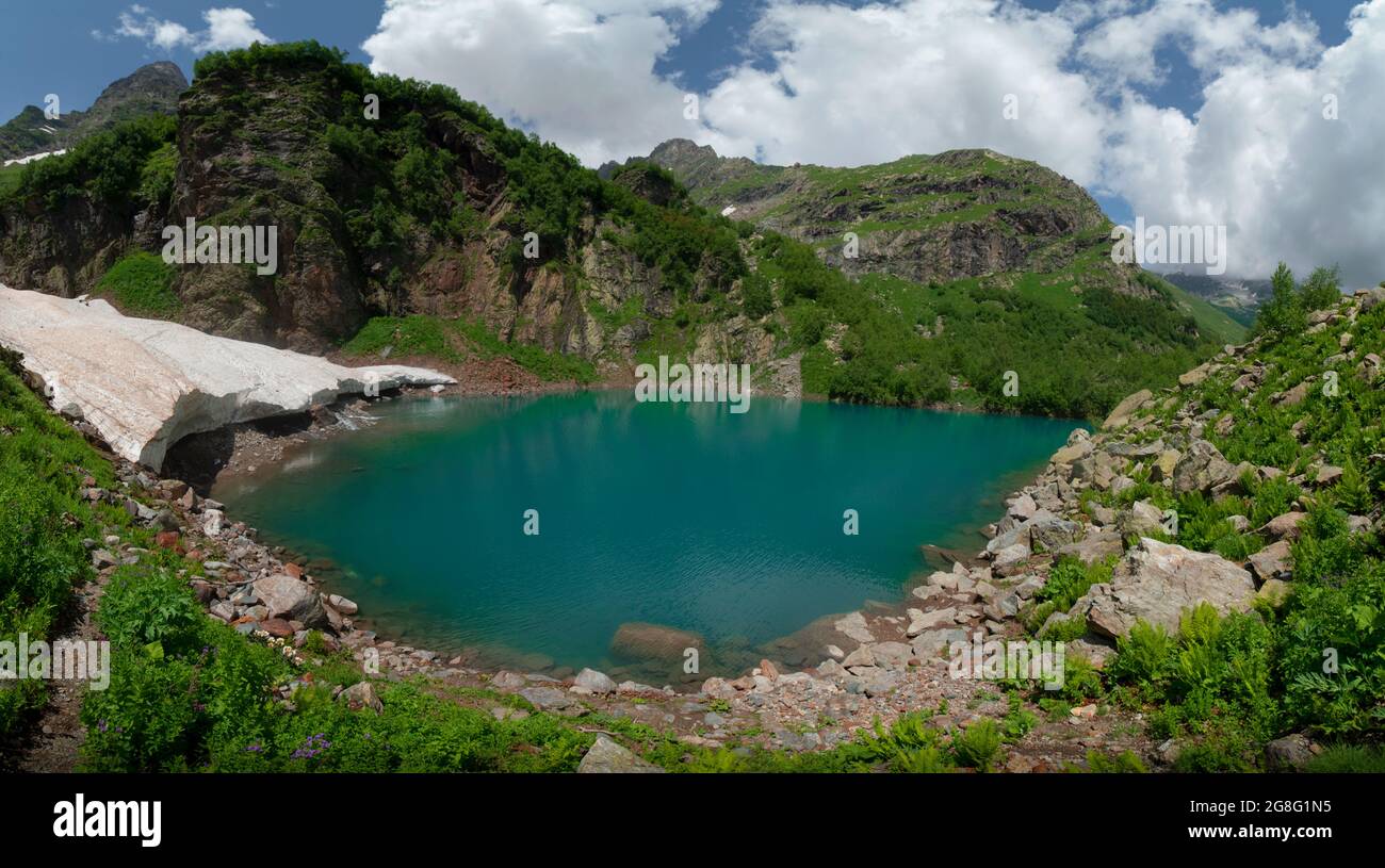 mountain lake Turie with the remains of an avalanche in Dombai Stock ...
