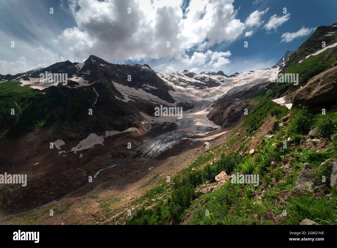 Alibek mountain gorge with remnants of a glacier and snow in Dombai in ...