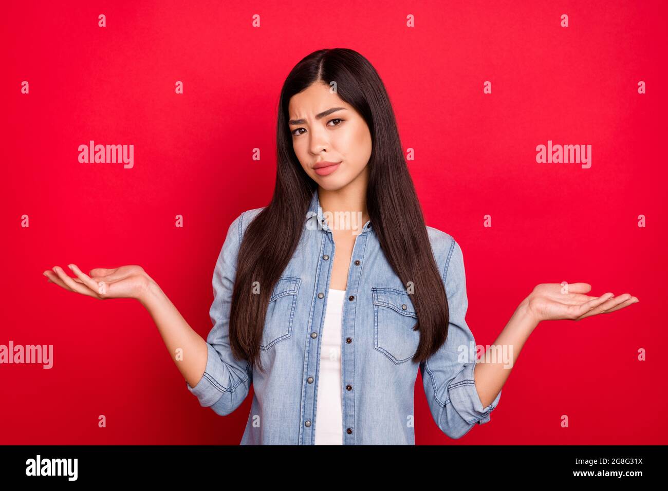 Portrait of attractive clueless girl shrugging shoulders dont know ...