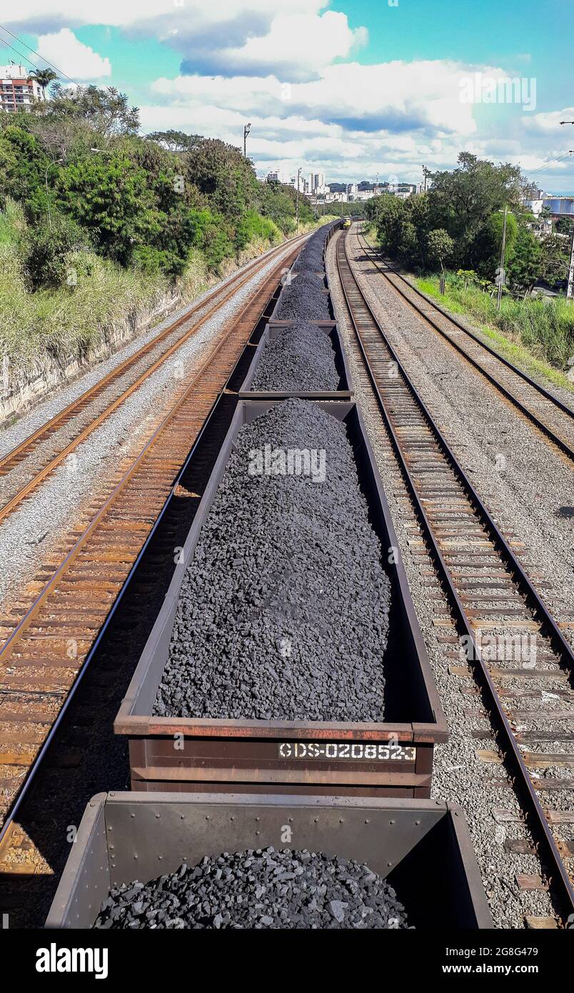 Vertical high angle shot of the train tracks surrounded by trees and ...