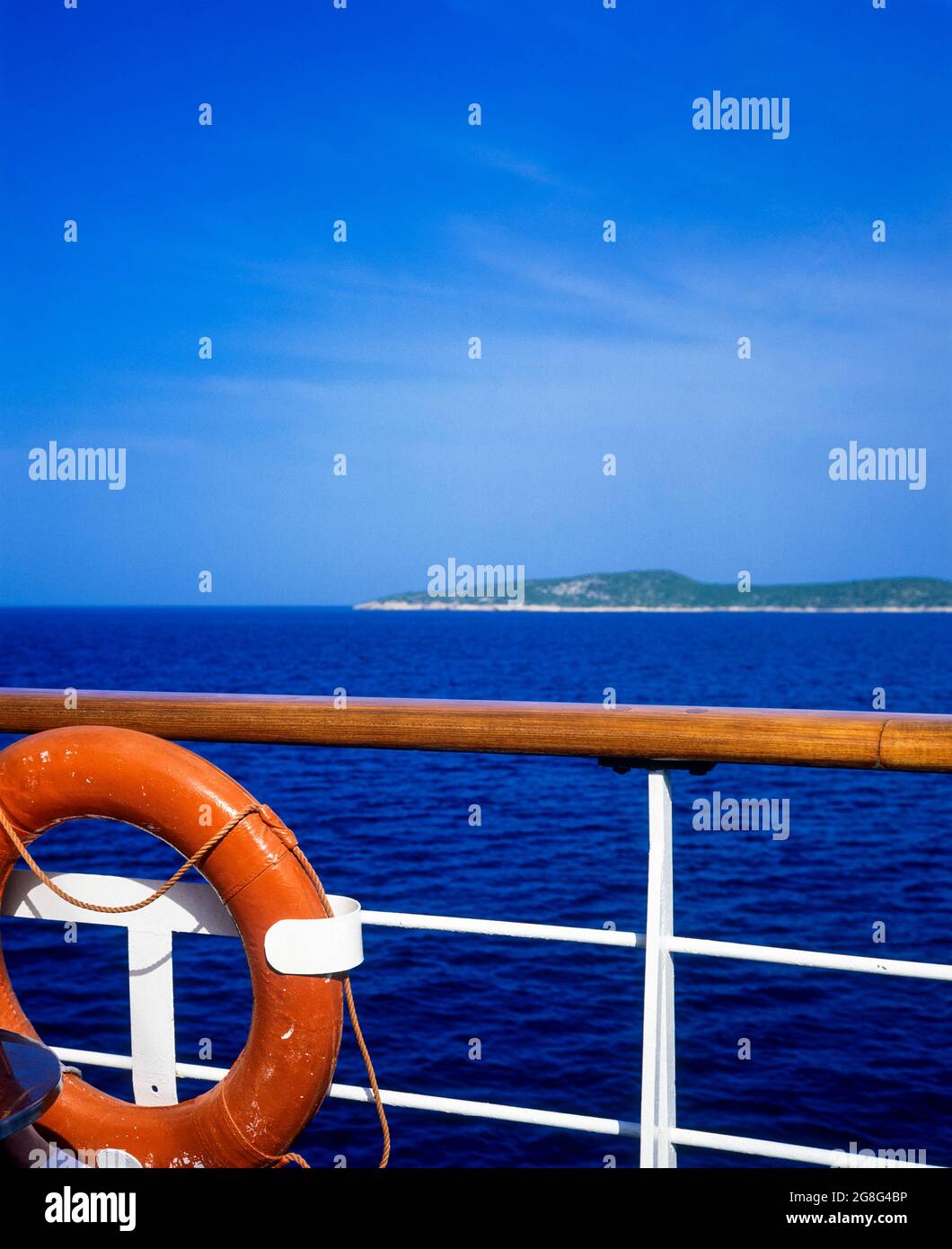 Cruise ship's rail, red lifebelt, Greek mainland's shoreline, Saronic ...