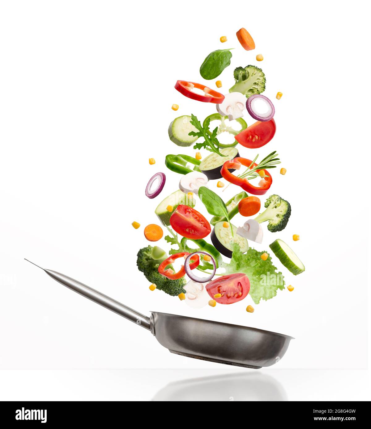 Fresh vegetables flying into a pan, isolated on white background Stock ...