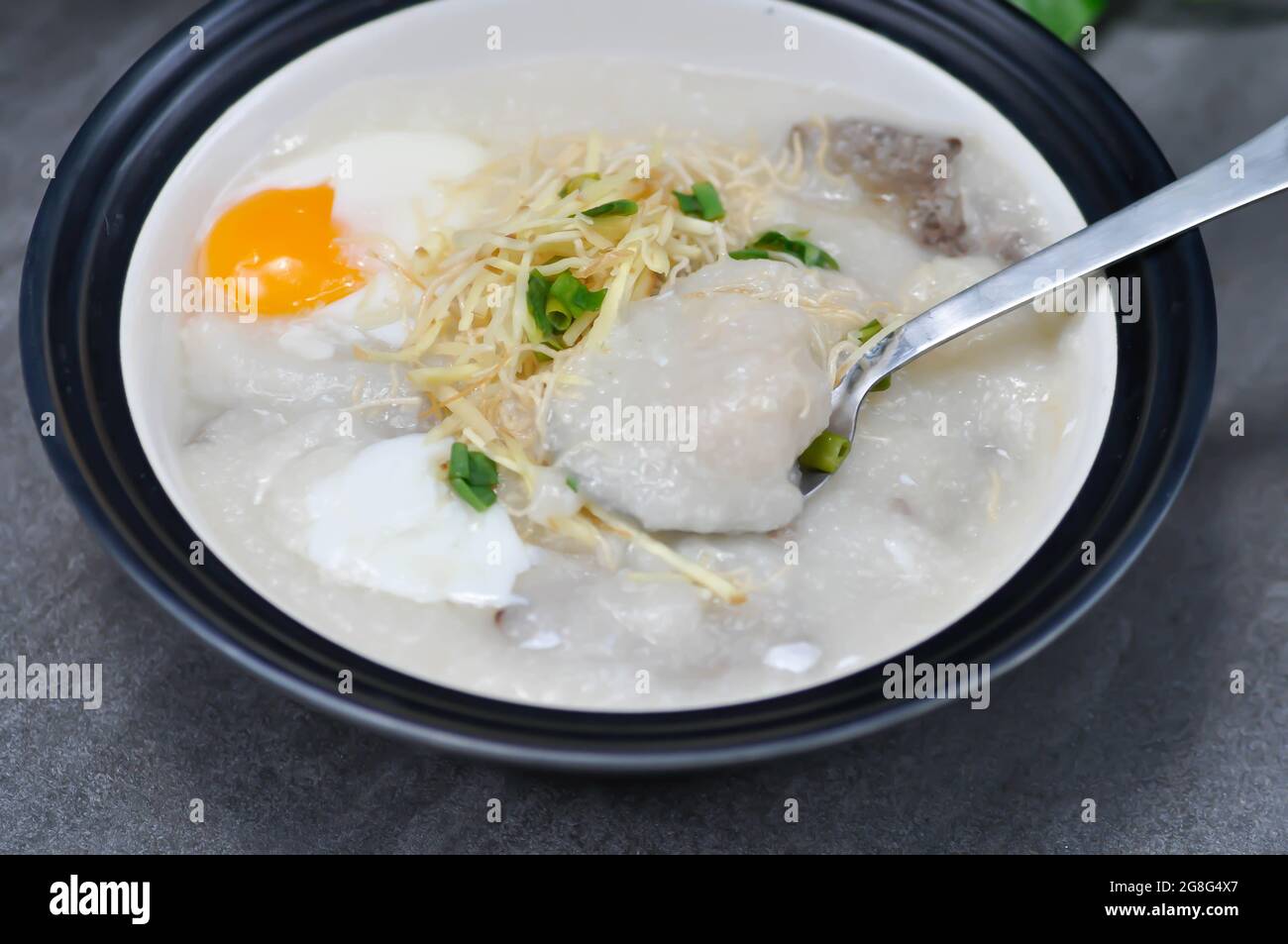 rice gruel, rice porridge or congee with pork and egg or eating rice ...