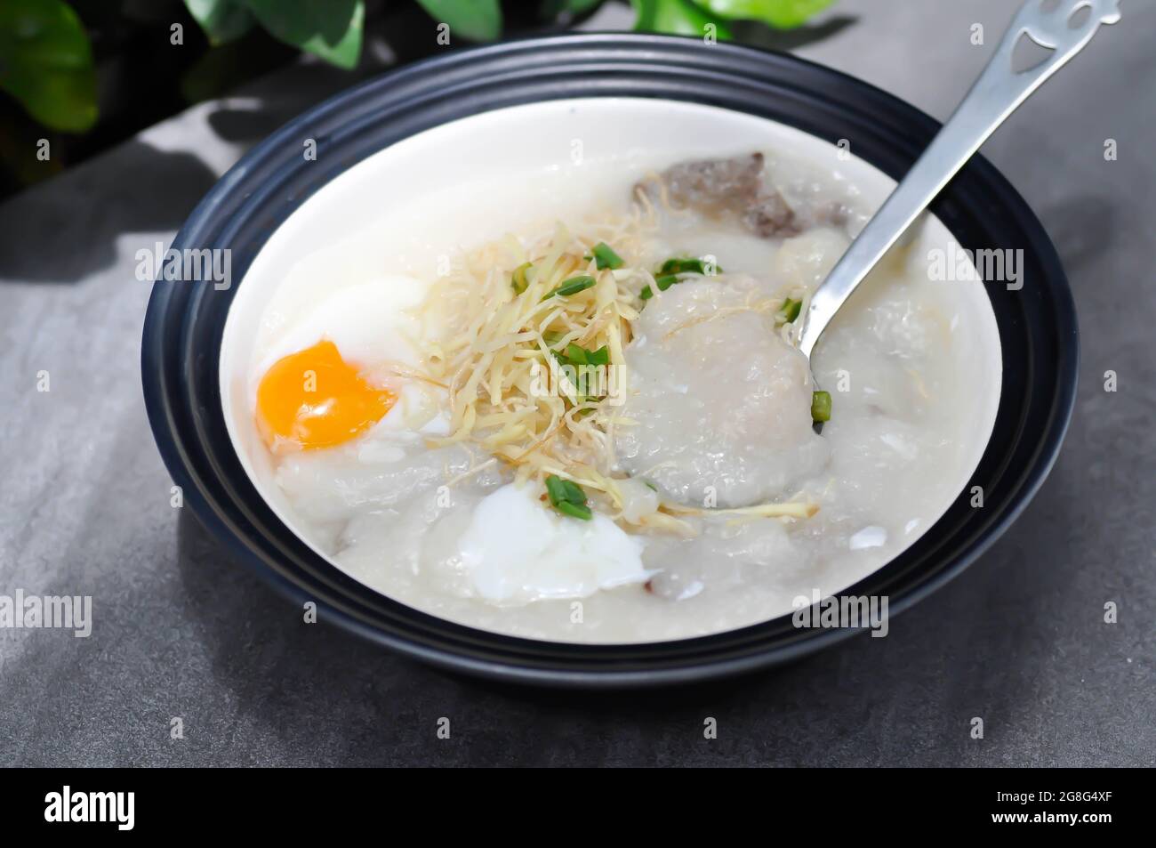 rice gruel, rice porridge or congee with pork and egg or eating rice ...