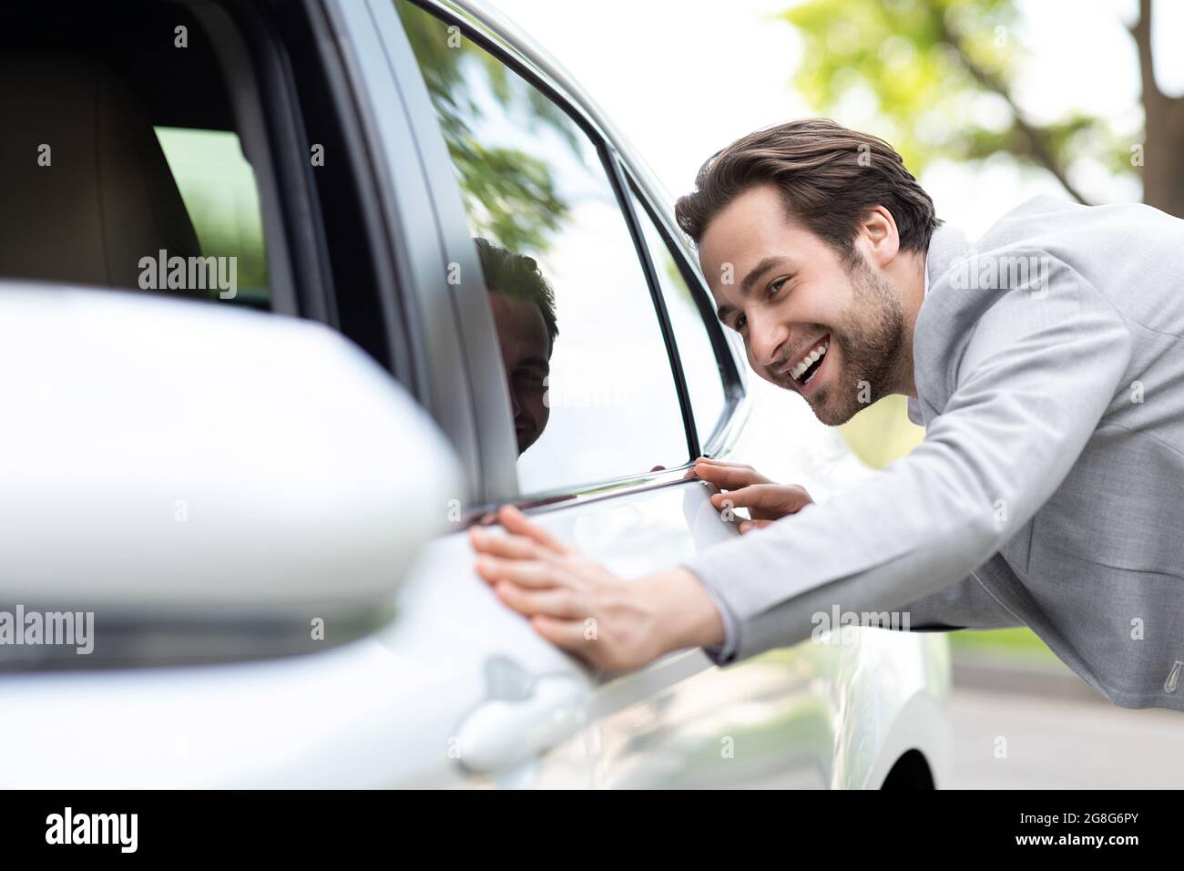 Happy man touching car in hi-res stock photography and images - Alamy