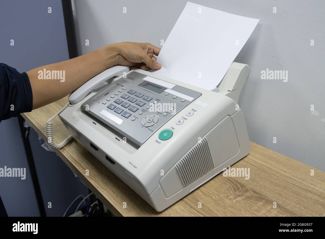 hand man are using a fax machine in the office, equipment for data ...