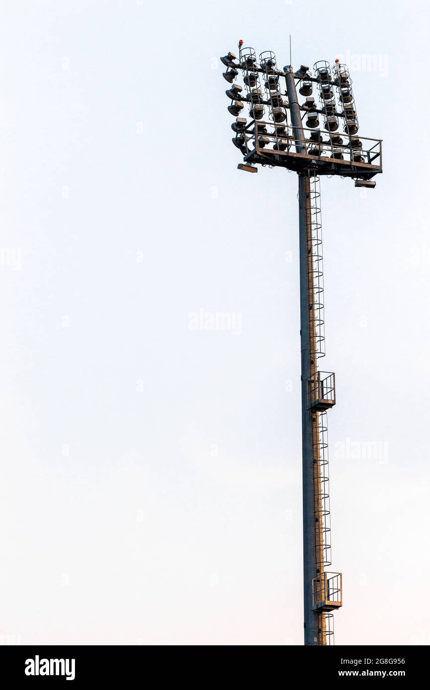 Vertical shot of a high tower with spotlights for stadium illumination ...