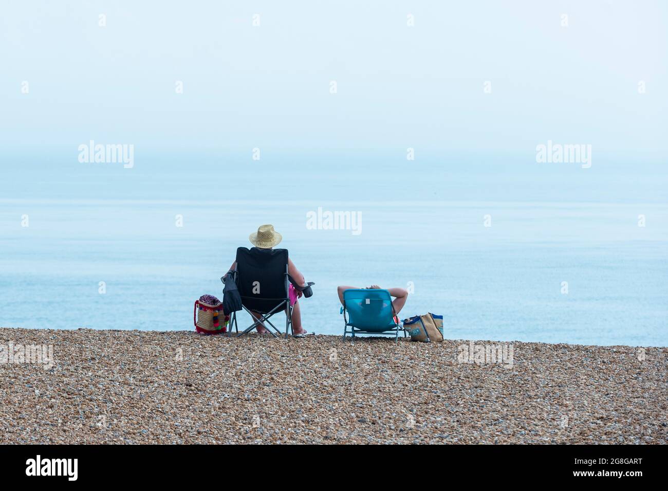 Folkestone, UK. 20 July 2021. UK Weather - People on the shingle beach ...