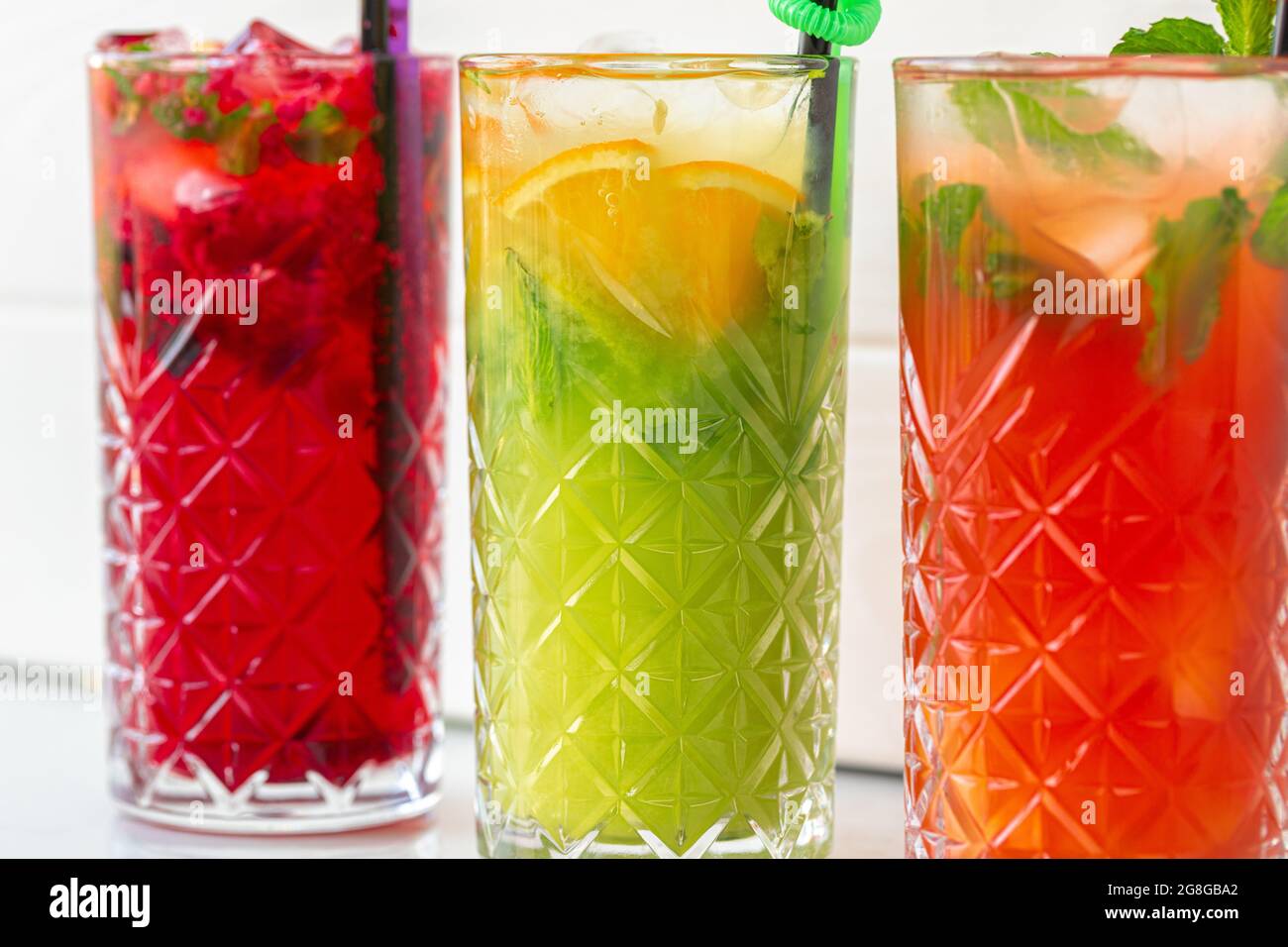 Three different refreshing lemonades on white wooden background Stock ...